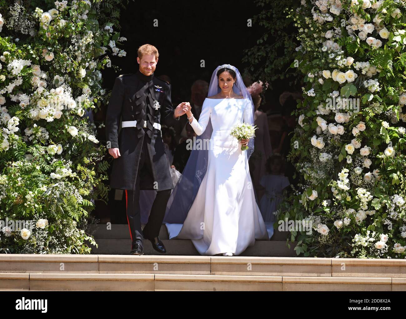 Britain's Prince Harry and Meghan Markle kiss as they exit St George's ...