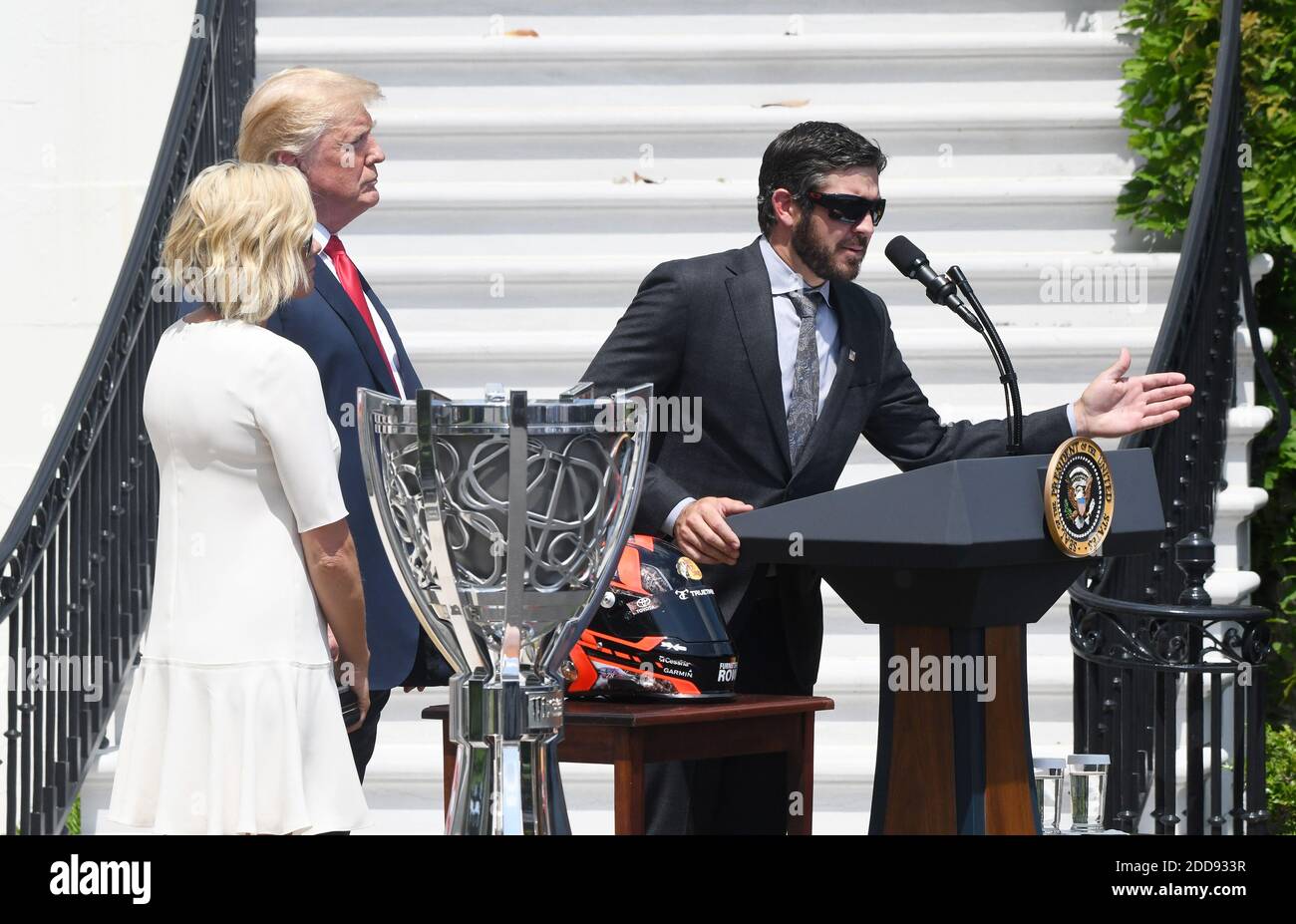 U.S. President Donald Trump is presented with a replica helmet from ...