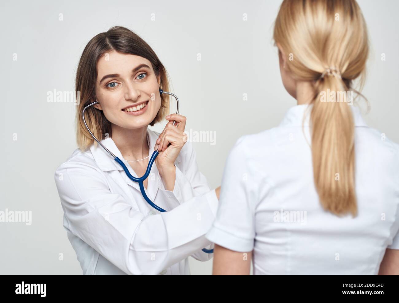 nurse in medical gown stethoscope and patient back view Stock Photo - Alamy