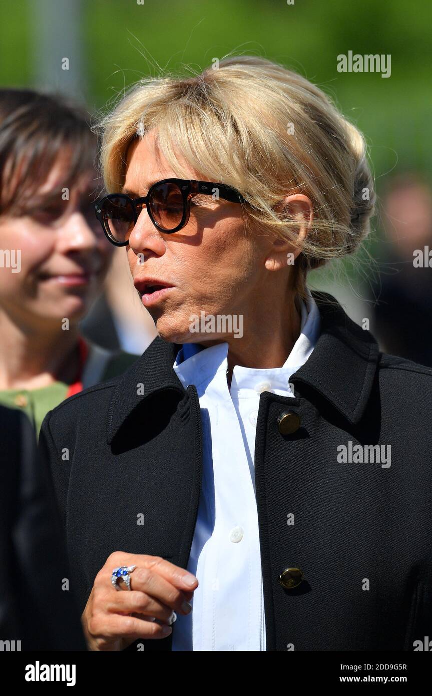 First Lady Brigitte Macron take part in a ceremony to lay flowers at ...