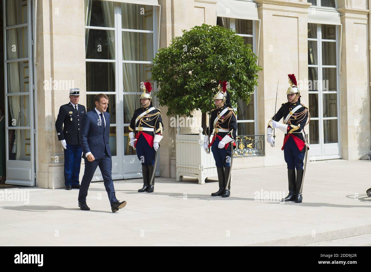 French President Emmanuel Macron arrives in the garden at the Elysee ...