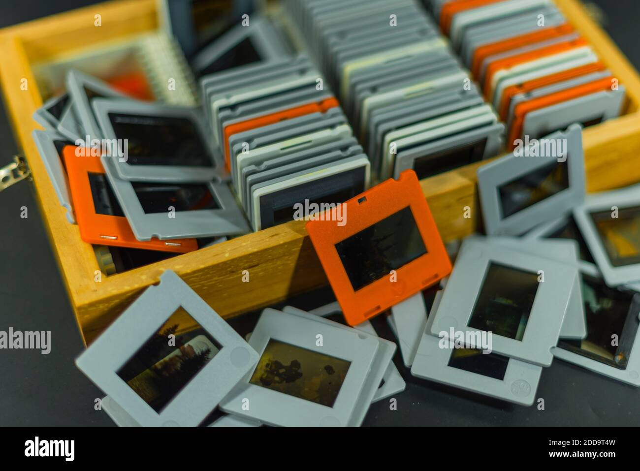 A wooden box with old slides in it, slides in a wooden box, slightly ...