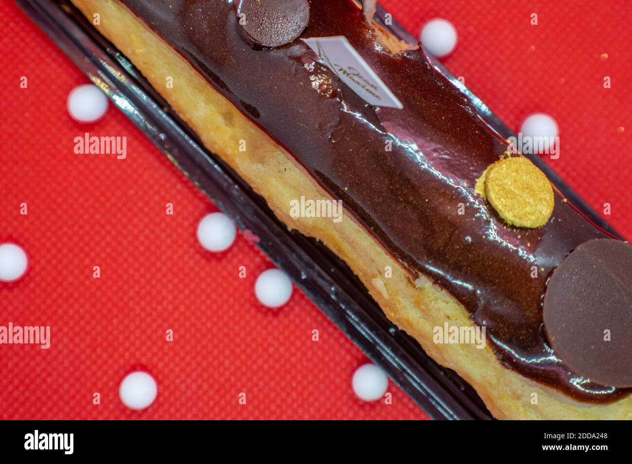 Christmas chocolate Eclair. French Eclair, cake on a Red background ...