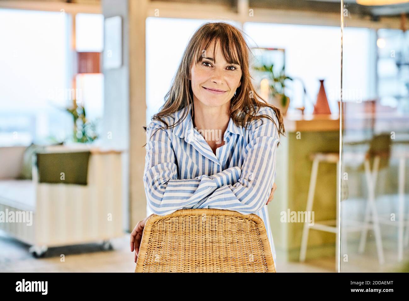 Mature woman standing chair hi-res stock photography and images - Alamy