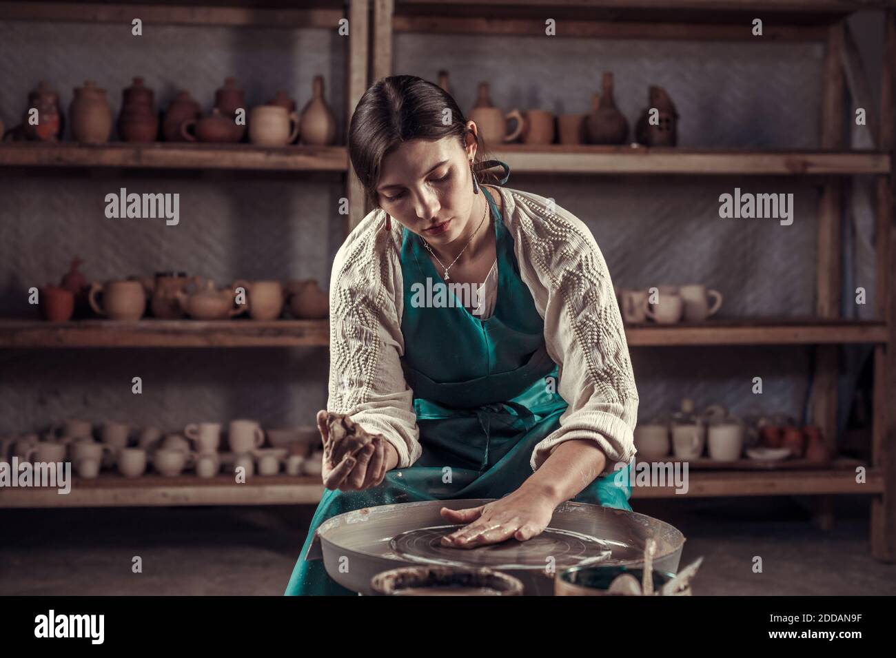 Charming artisan master demonstrates the process of making ceramic ...
