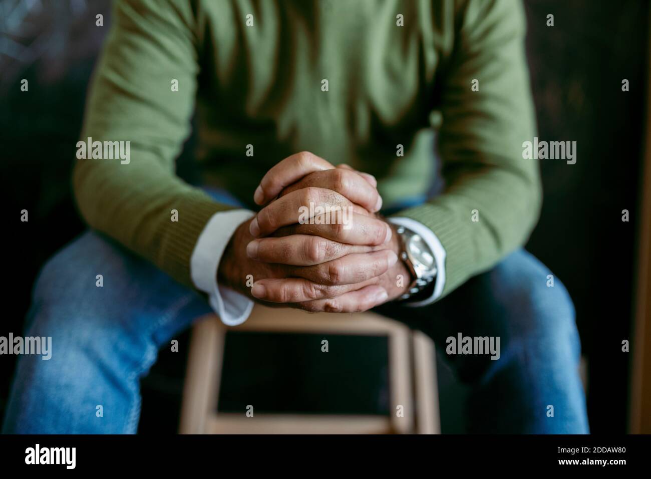Sitting hands folded hi-res stock photography and images - Alamy