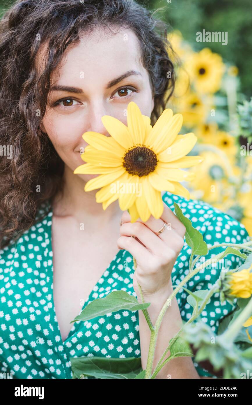 Beautiful young woman holding flower hi-res stock photography and ...