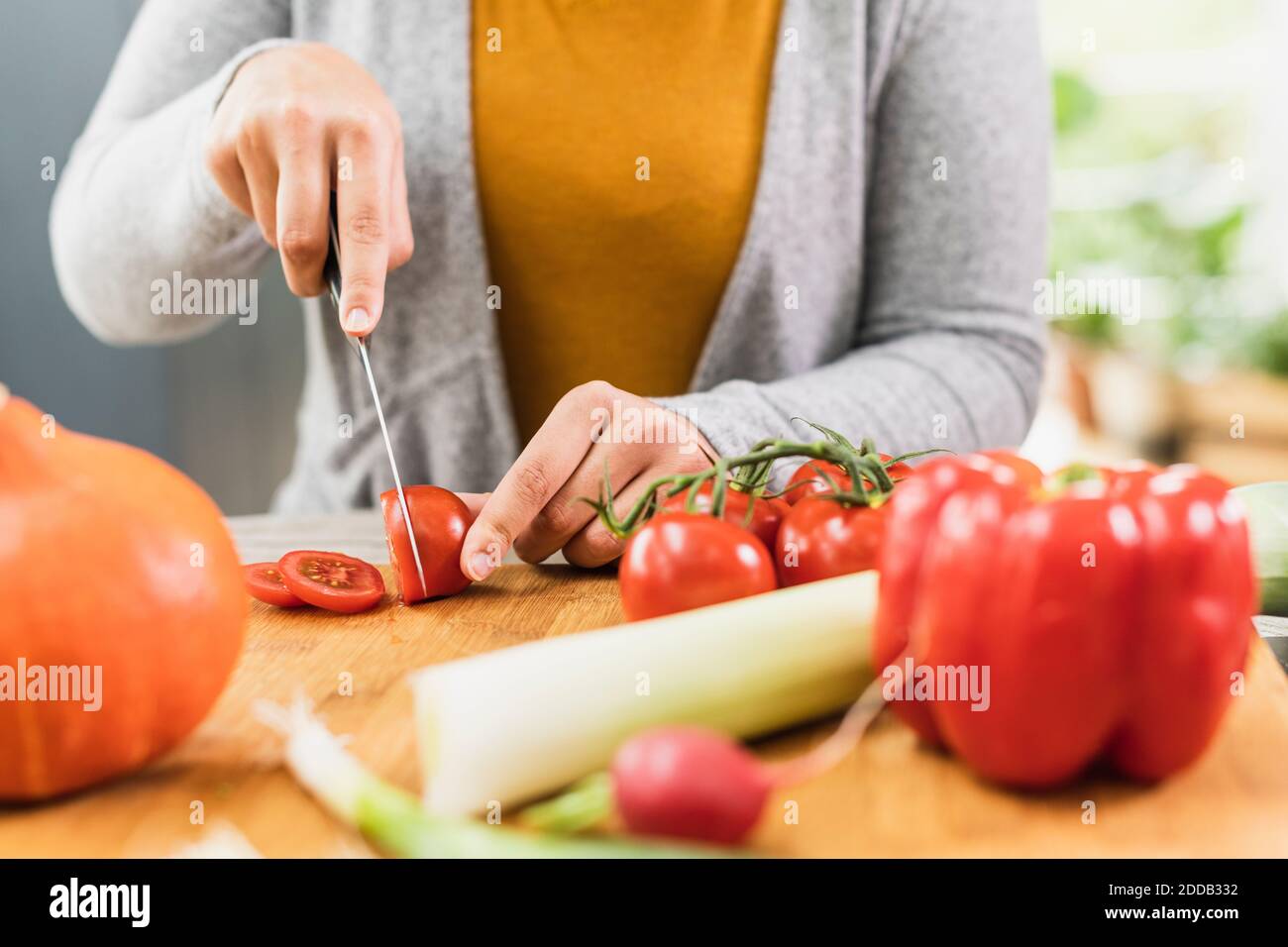 Woman cutting tomato hi-res stock photography and images - Alamy
