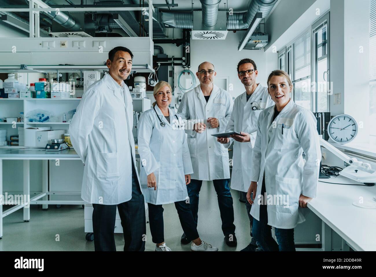 Confident scientist team standing together at laboratory Stock Photo ...