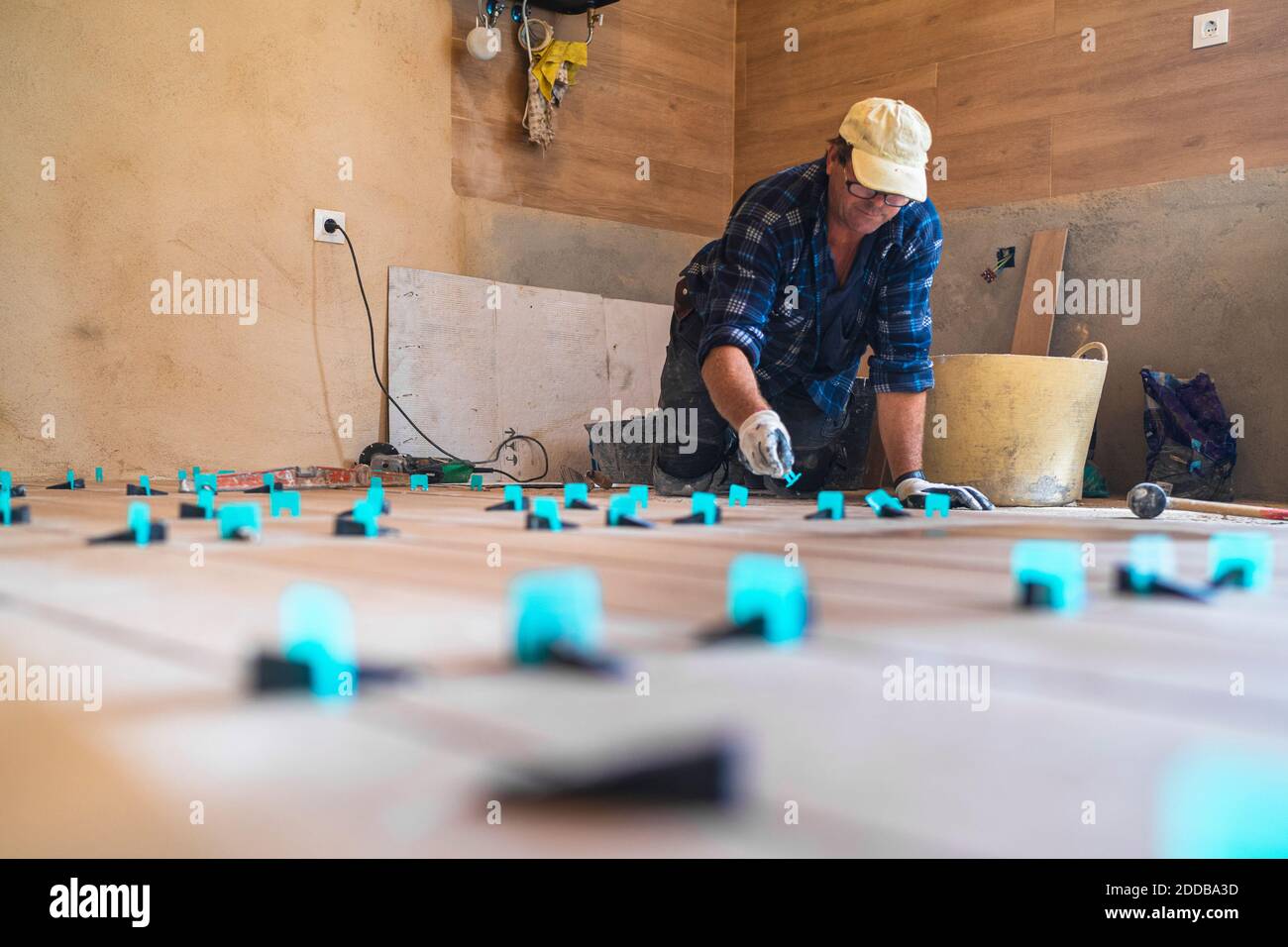 Mature man working on parquet floor in house Stock Photo - Alamy
