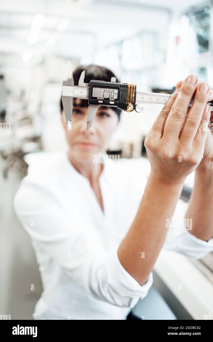 Female engineer concentrating on instrument of measurement Stock Photo ...