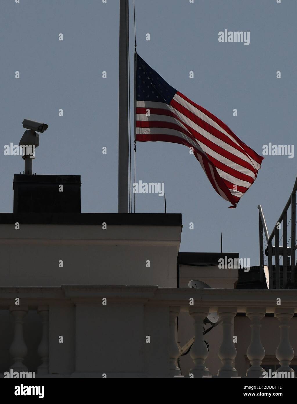 The U.S. flag is lowered to half-staff at the White House on July 3 ...
