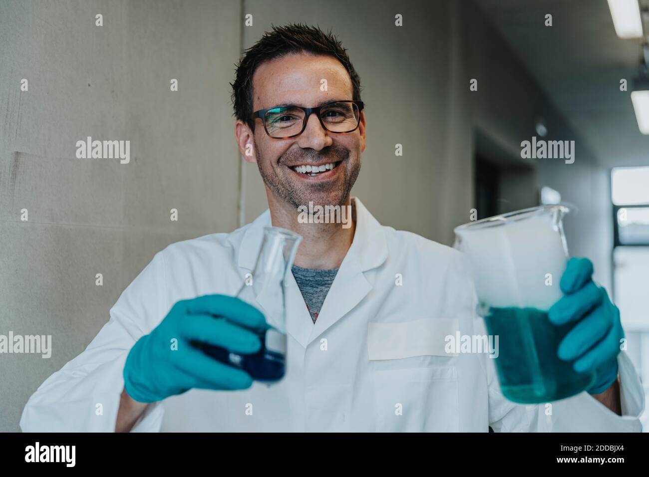 Scientist standing with liquid solution at clinic corridor Stock Photo ...