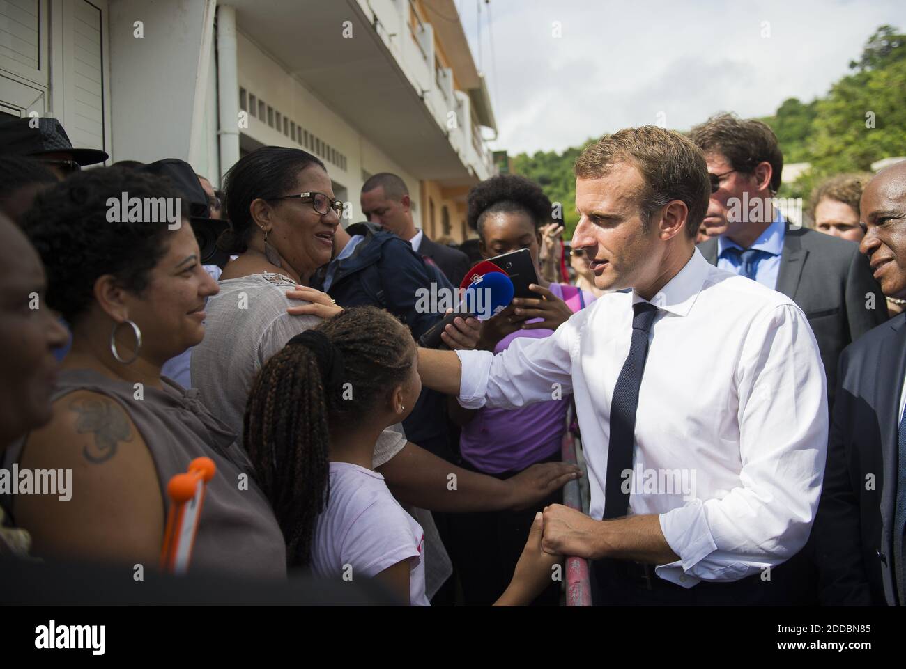 French President Emmanuel Macron listens to a bystander as he leaves ...