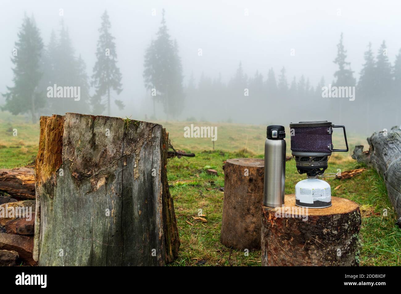Preparing a hot drink for a hike. Hot coffee in a thermos. Gas stove ...