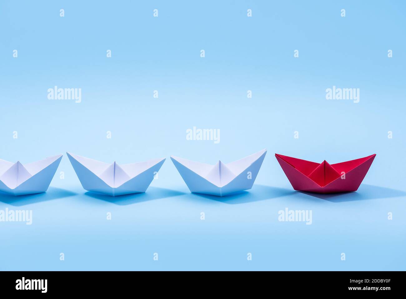 Red and white paper boats. Concept of leadership boats for teamwork ...