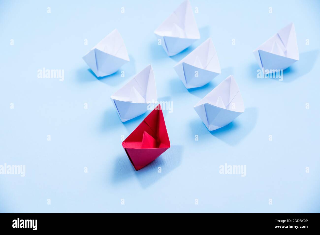 Red and white paper boats. Concept of leadership boats for teamwork ...
