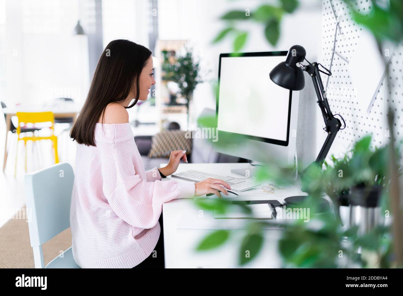 Young female influencer sitting desk hi-res stock photography and ...