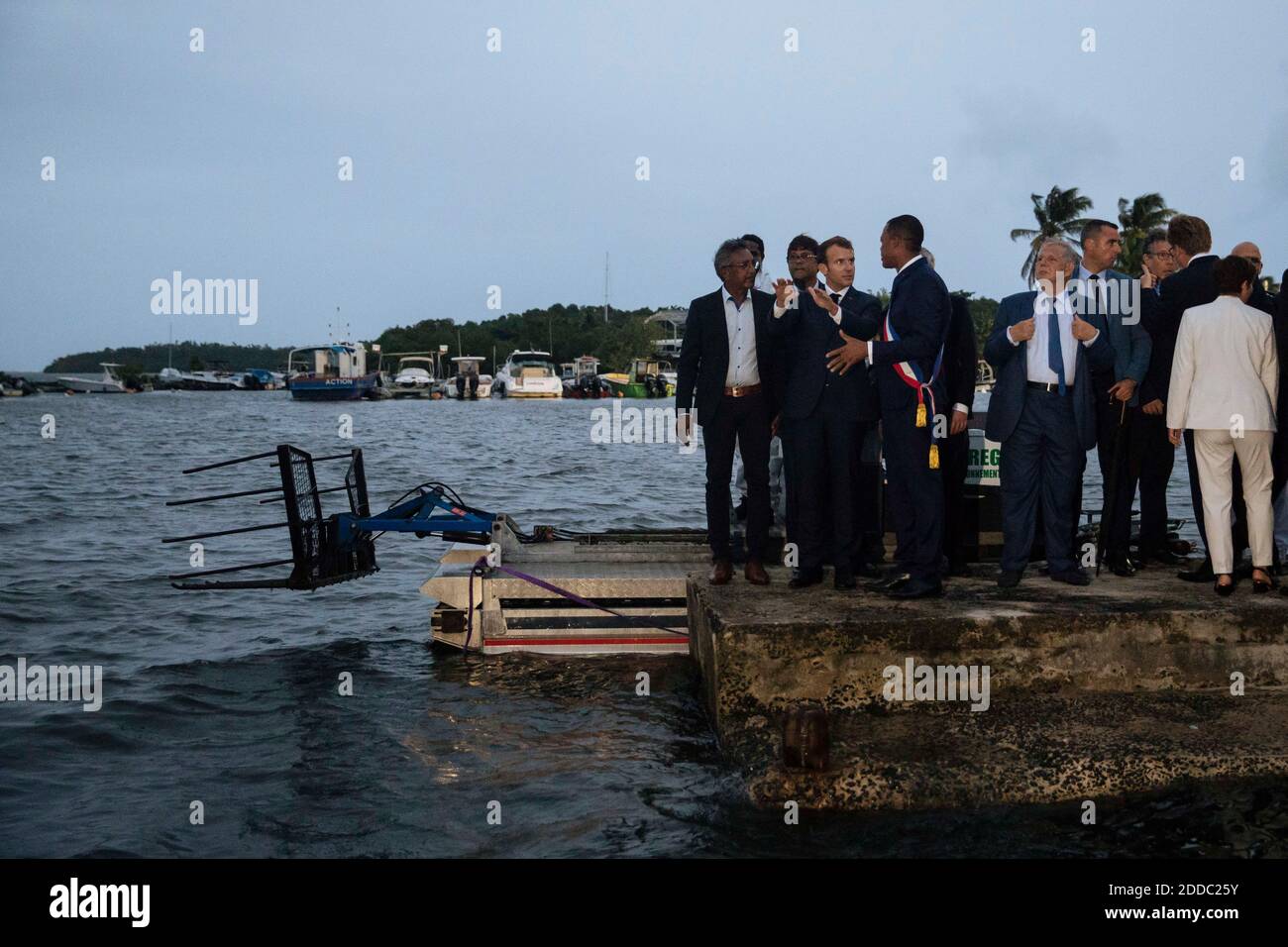 French President Emmanuel Macron is seen on a pier as he watches ...