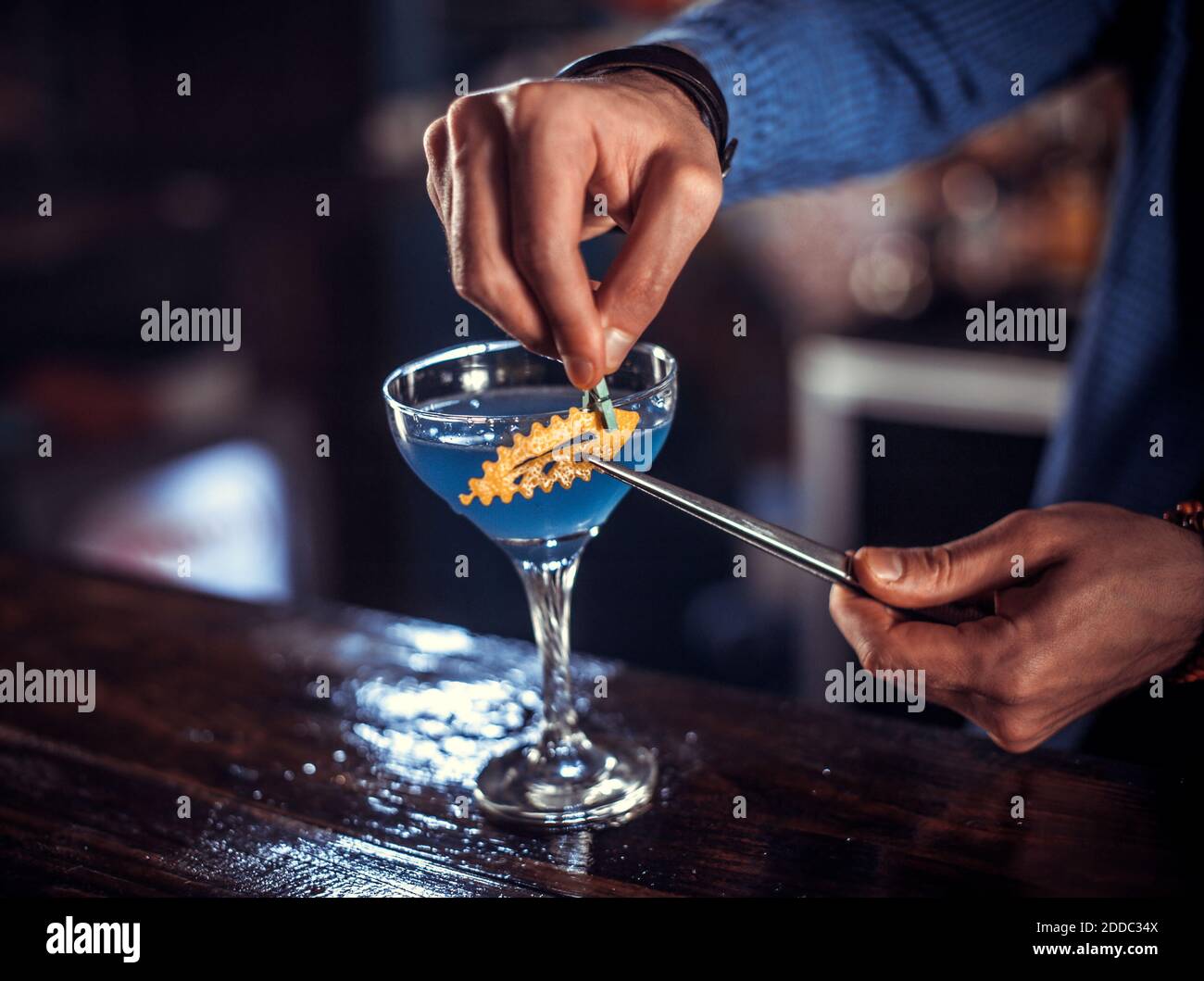 Professional tapster decorates colorful concoction in the bar Stock ...
