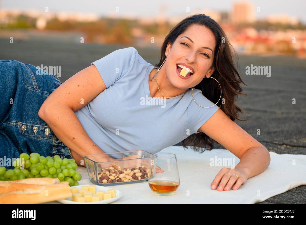 Young woman lying on roof hi-res stock photography and images - Alamy