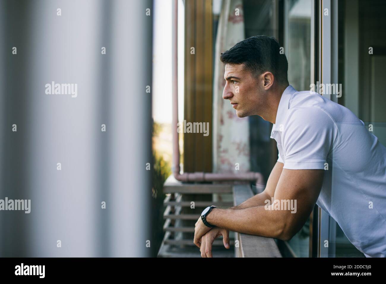 Man leaning on balcony railing hi-res stock photography and images - Alamy