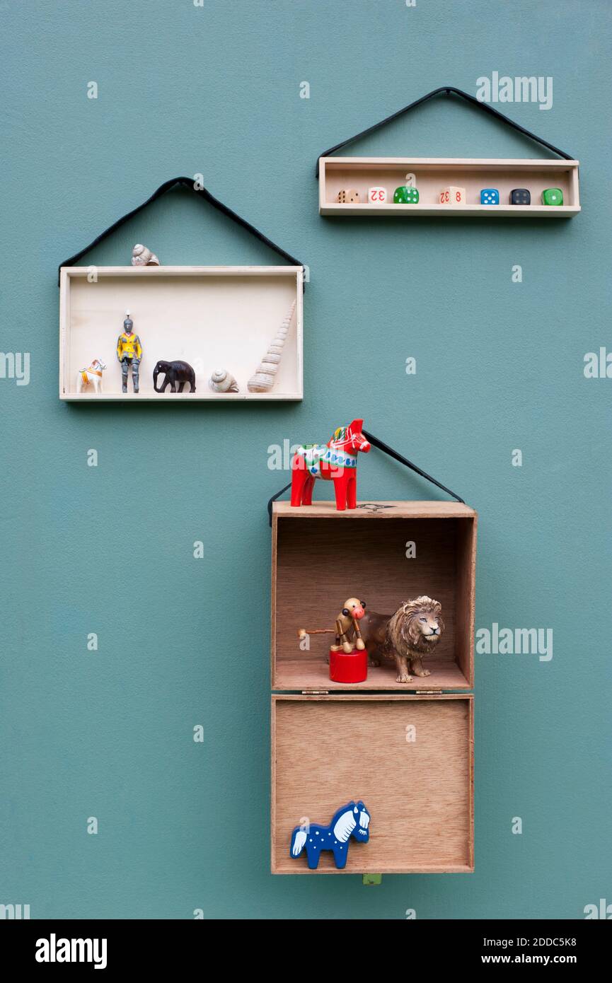 Toys on DIY shelves hanging on leather strips Stock Photo - Alamy