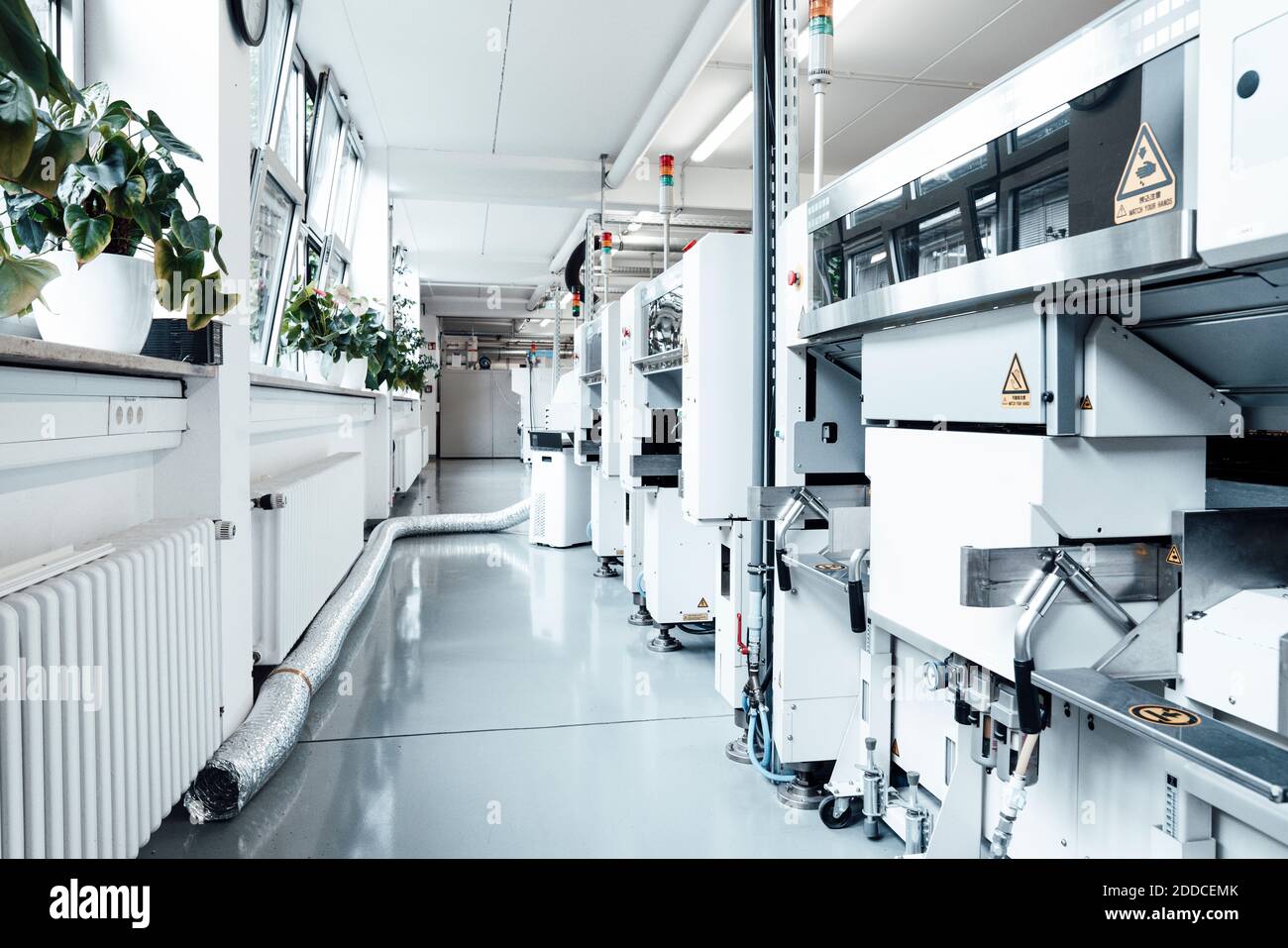 Machineries in illuminated bright manufacturing industry Stock Photo ...