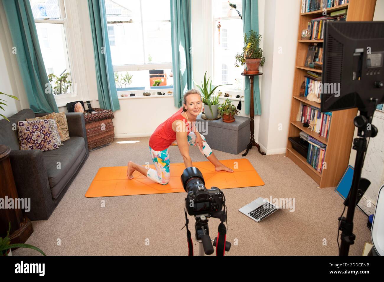 Fitness woman doing exercise video recording with camera at home Stock ...