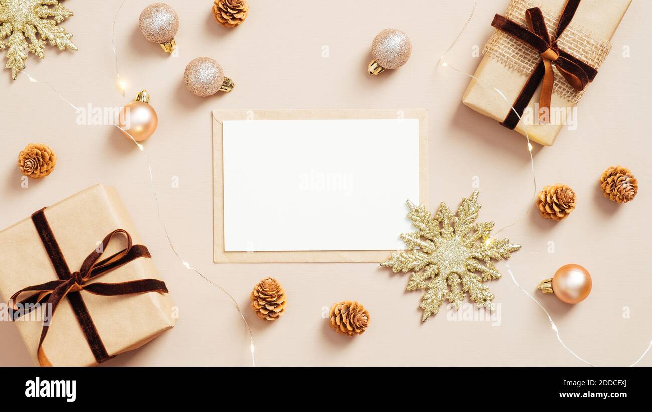 Christmas card mockup on pastel beige background with gift boxes ...