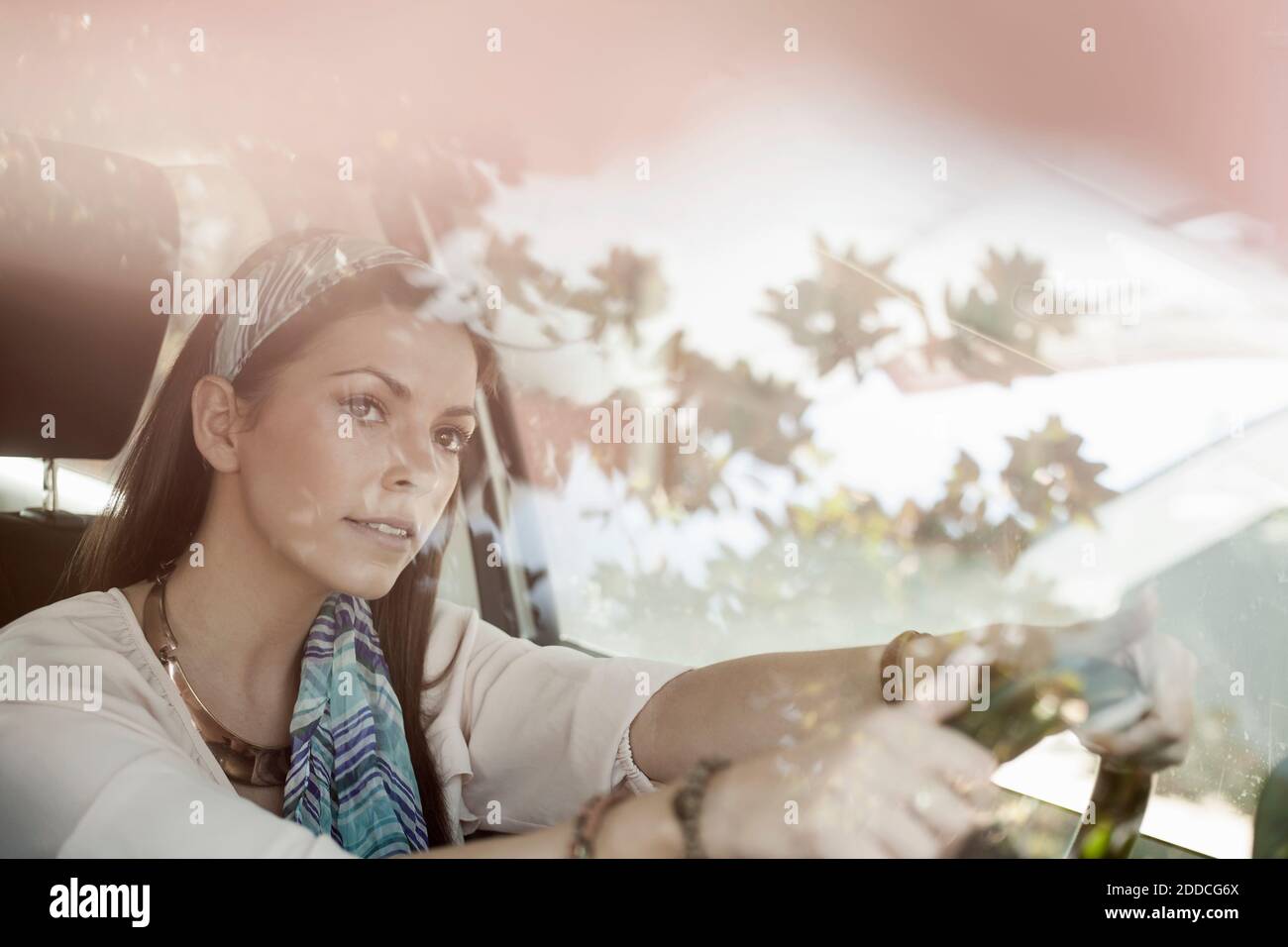 Young woman driving car seen through windshield Stock Photo - Alamy