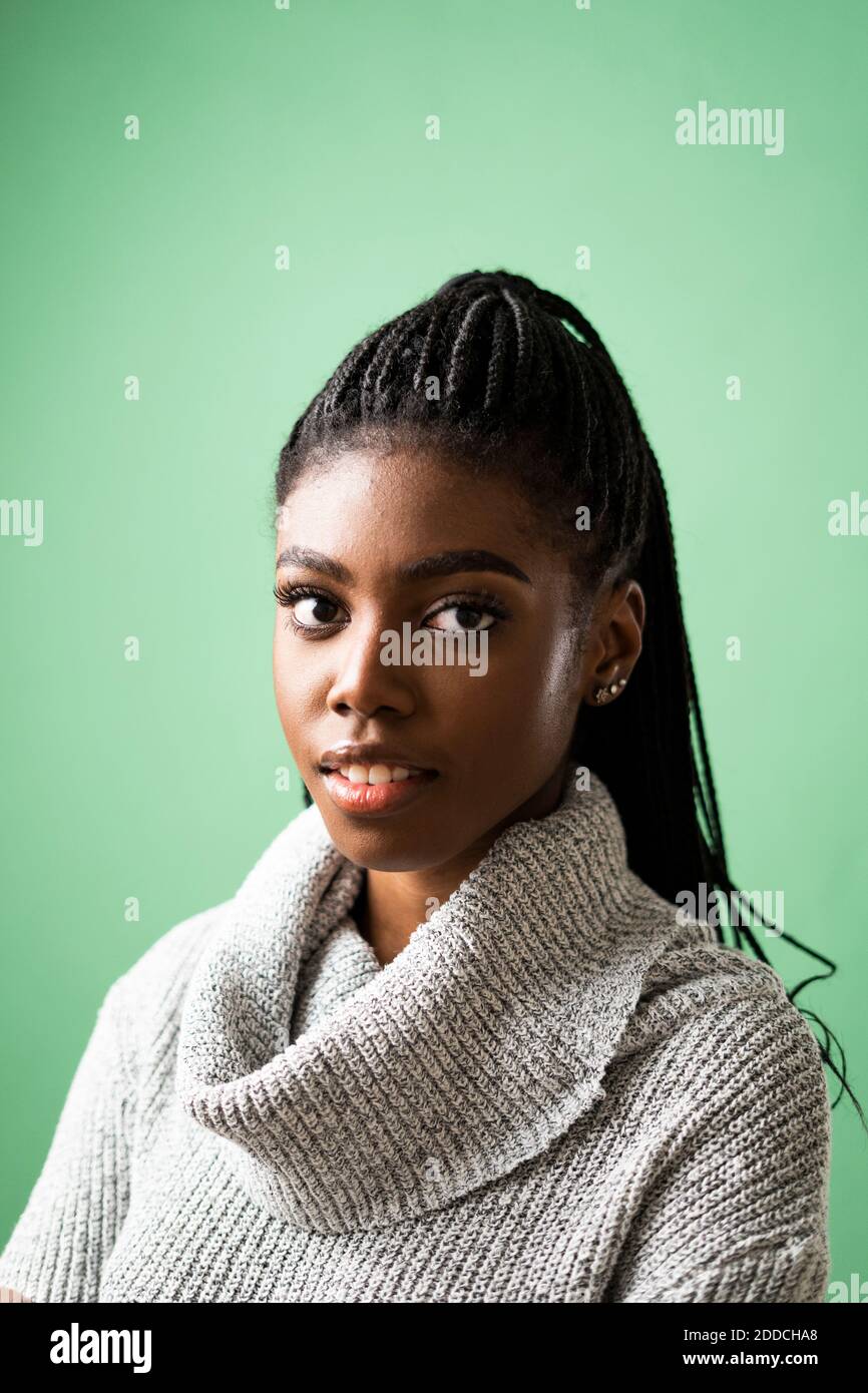 Young woman against green background in studio Stock Photo - Alamy