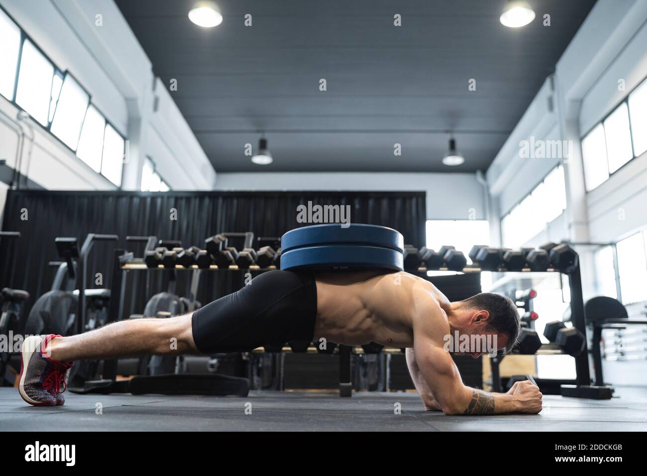 Male athlete doing plank position in health club Stock Photo - Alamy