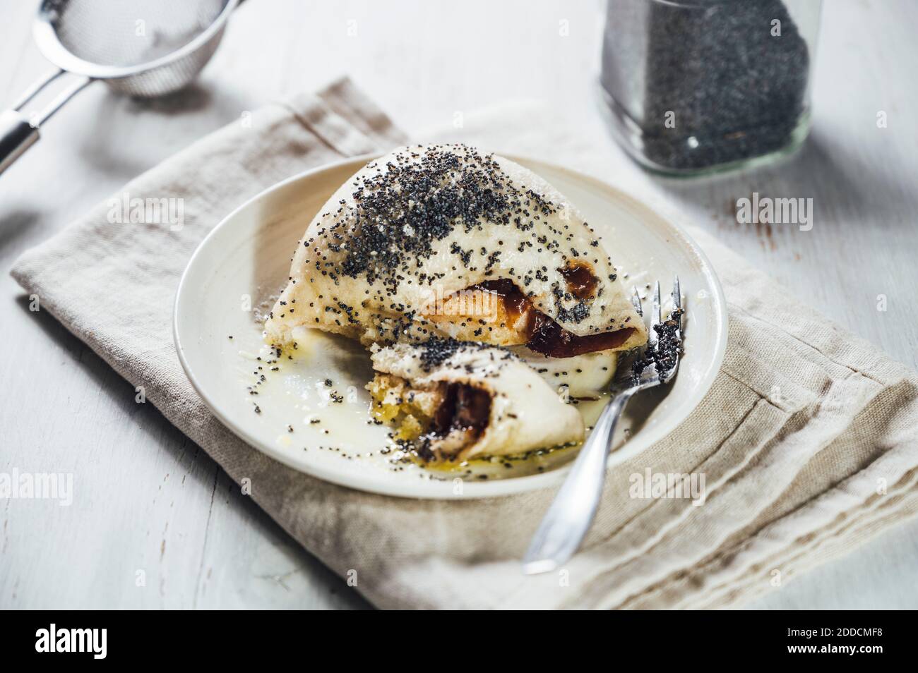 Sweet Germknodel dumpling with poppy seeds and plum jam Stock Photo - Alamy