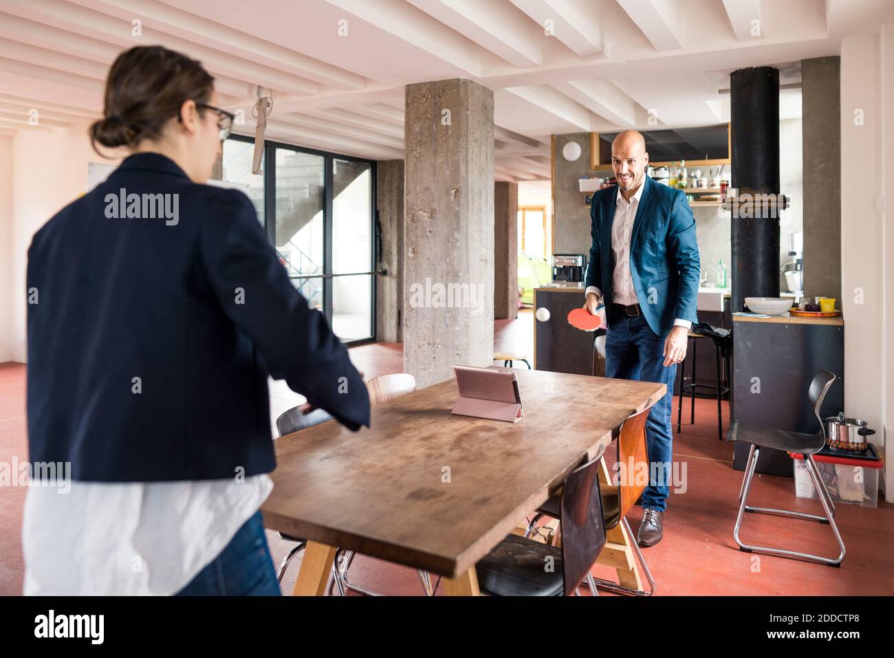 While colleagues playing table tennis hi-res stock photography and ...