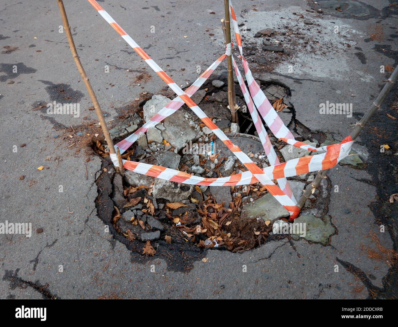 Top view of the dangerous sewer manhole. Asphalt collapse Stock Photo ...