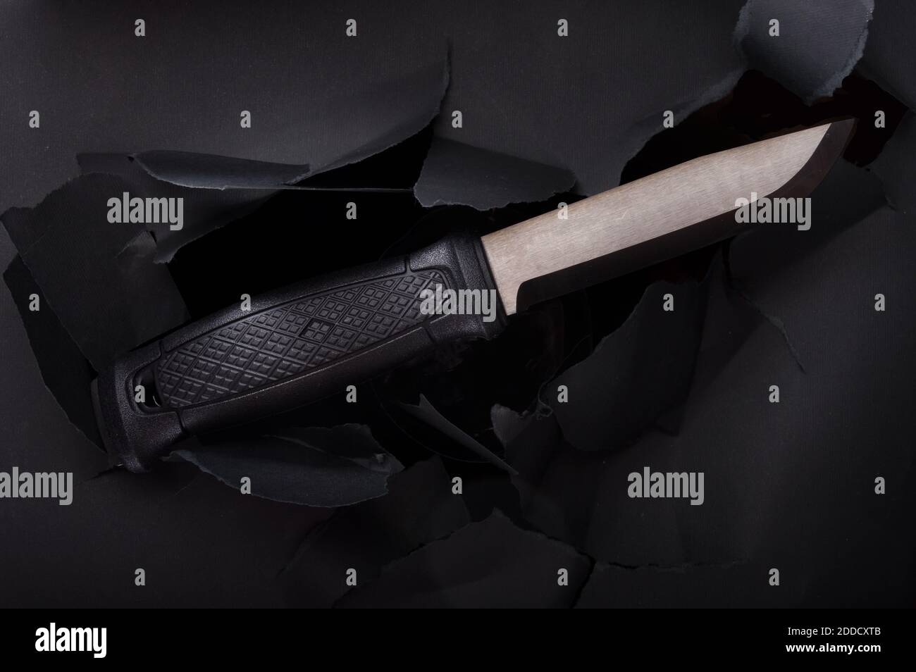 A beautiful photo of a black knife on a black background. Large hunting ...