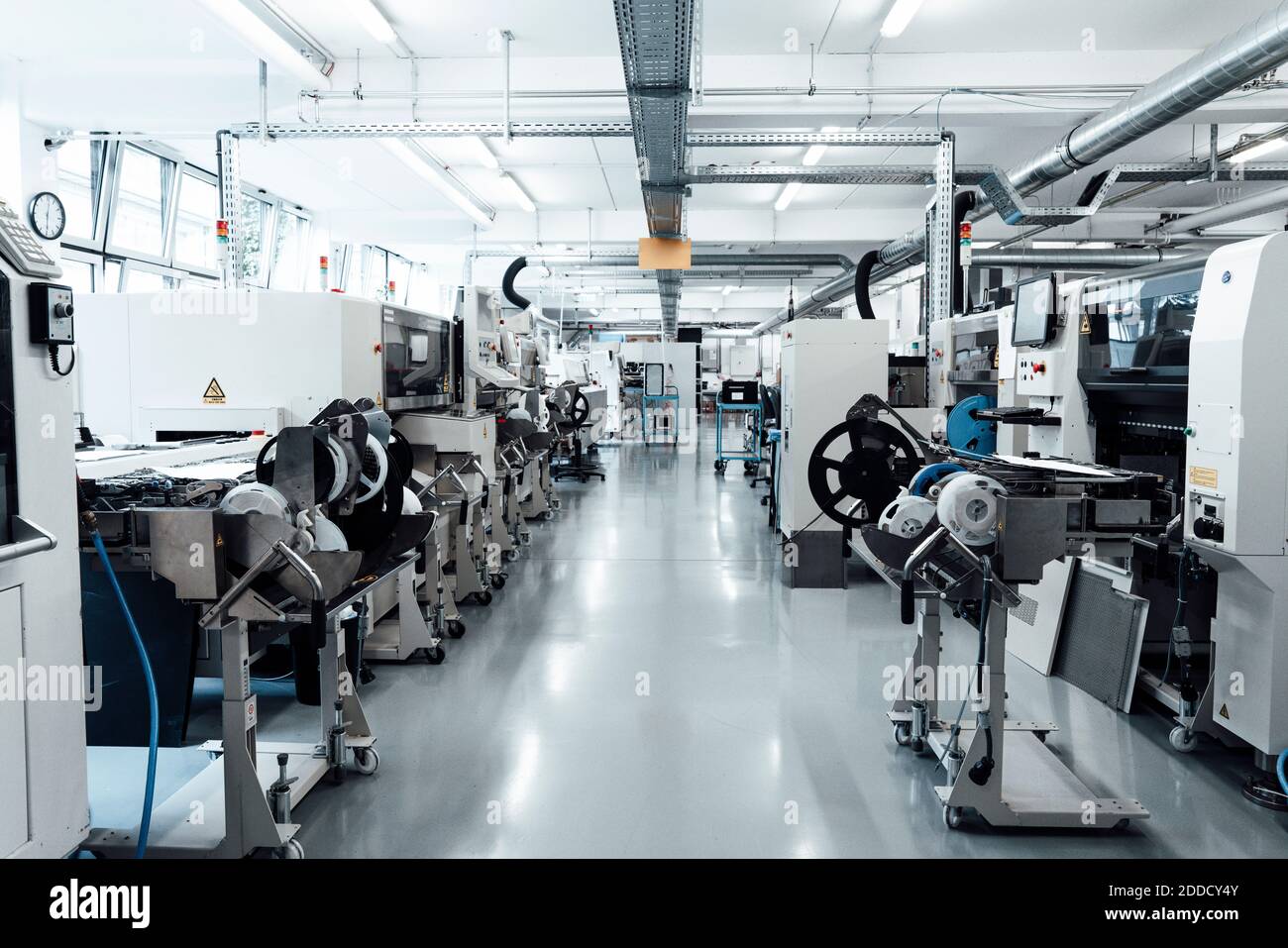 Machineries in illuminated manufacturing industry Stock Photo - Alamy