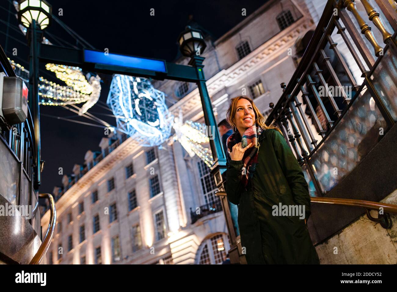 Woman standing under street lights hi-res stock photography and images ...