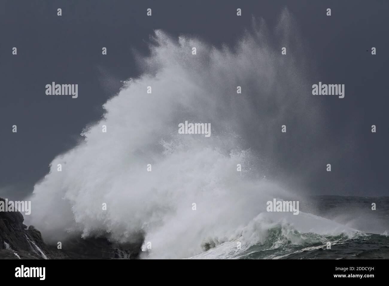 Big stormy wave splash against dark rainy sky Stock Photo - Alamy