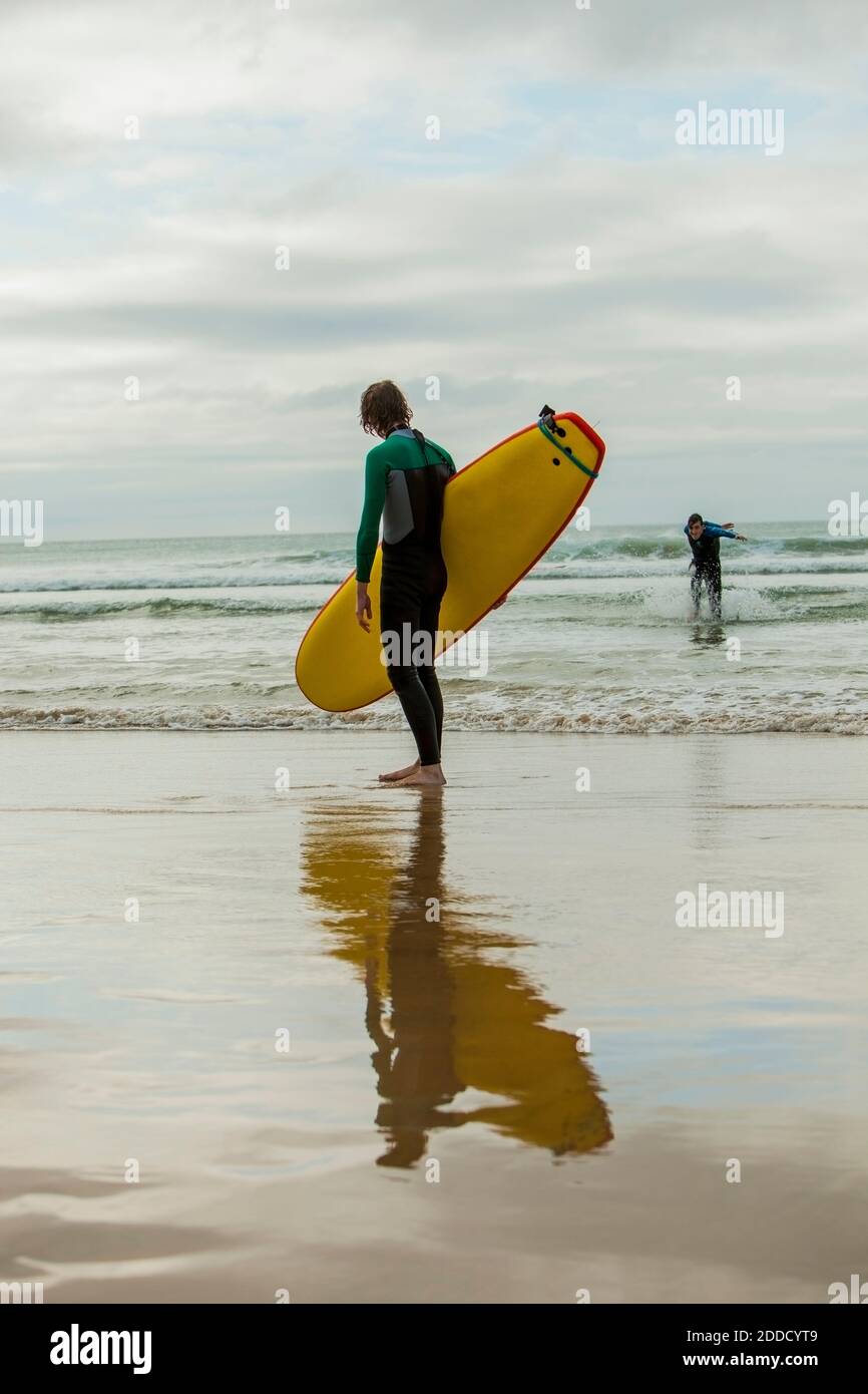 Two boys standing in sea hi-res stock photography and images - Alamy