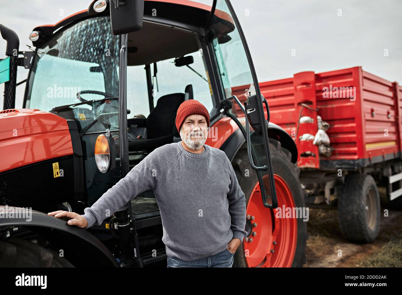 Farmer standing by tractor at soybean farm Stock Photo - Alamy