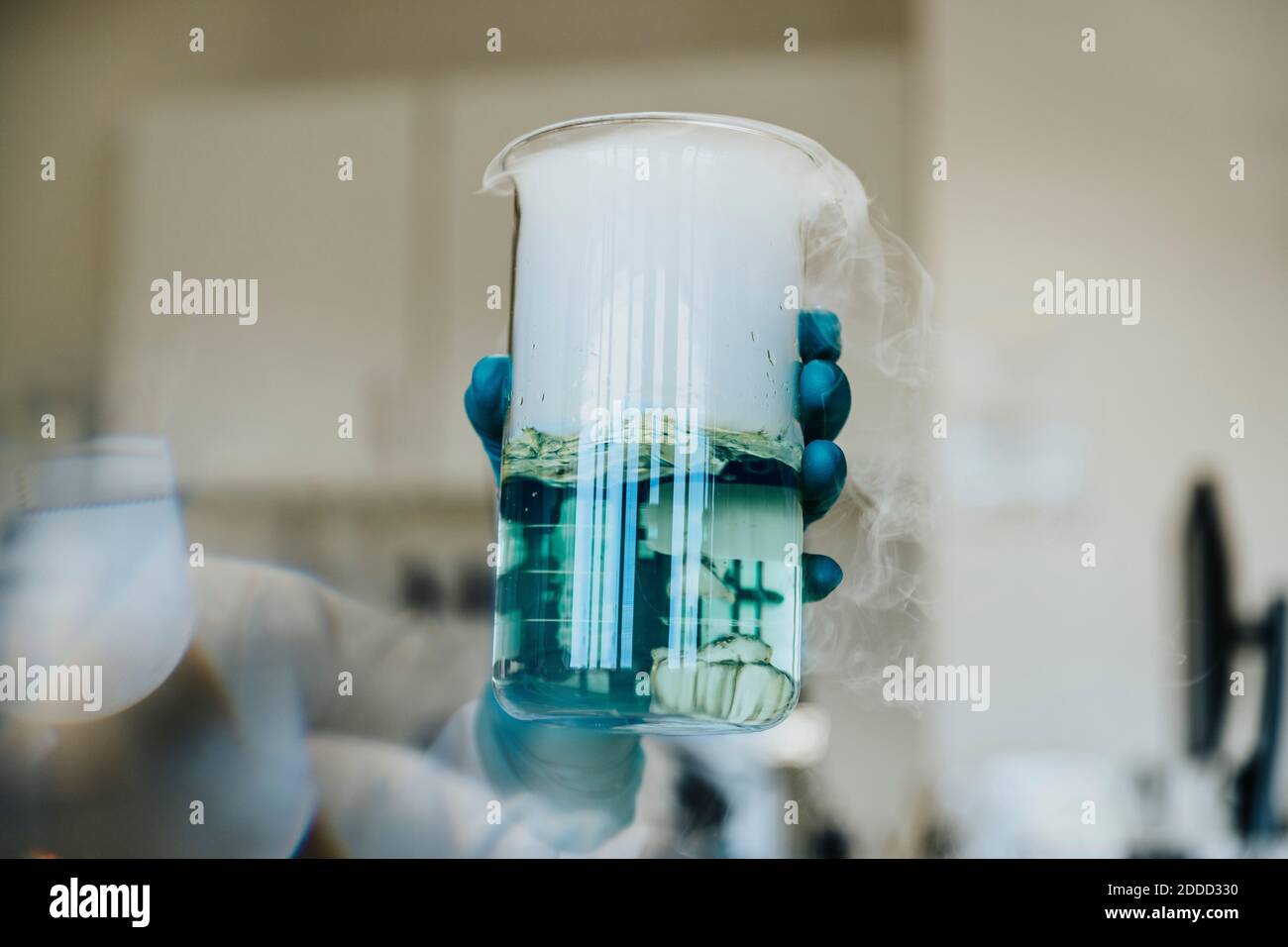 Woman hand holding liquid beaker at laboratory Stock Photo - Alamy