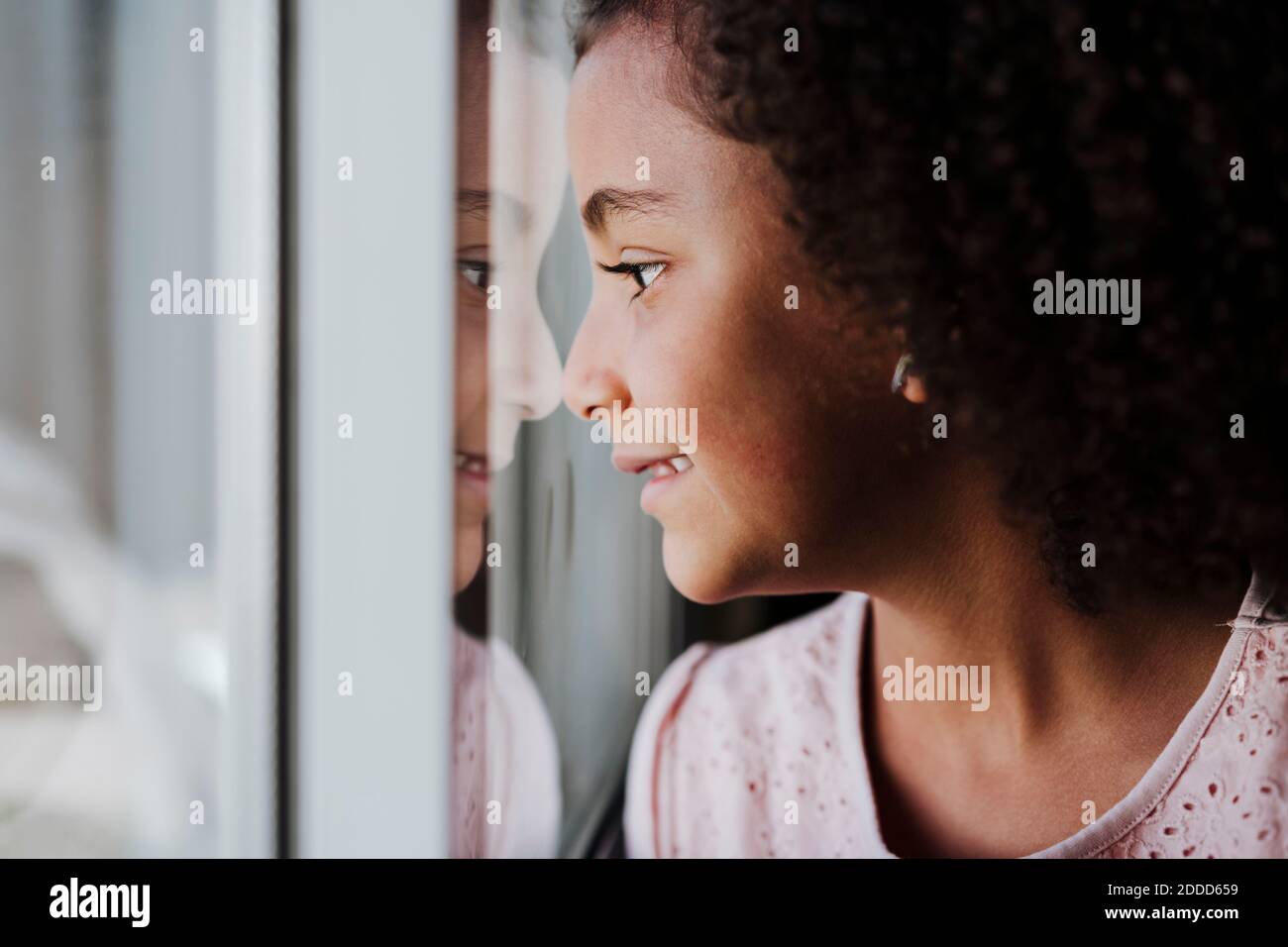 Black child looking through the window hi-res stock photography and images - Alamy