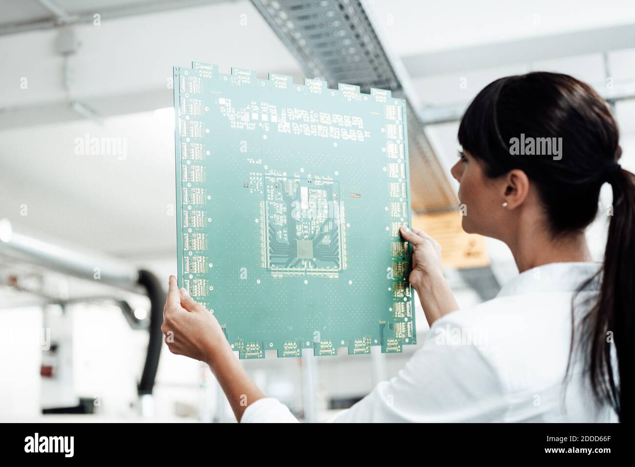 Mature businesswoman analyzing large computer chip in industry Stock ...