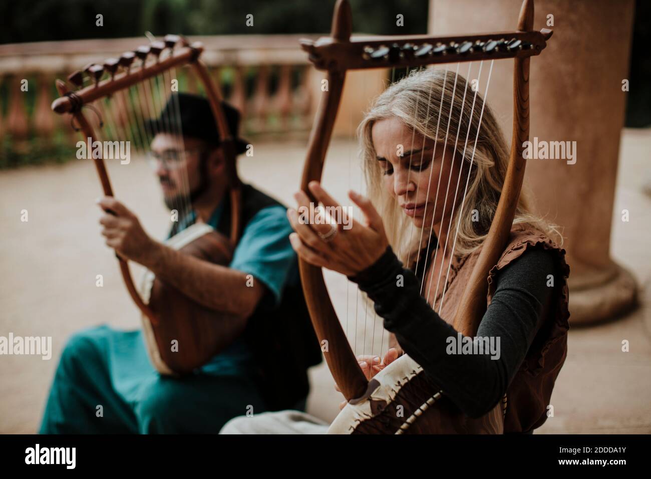 Female with male partner playing lyra instrument on staircase Stock ...