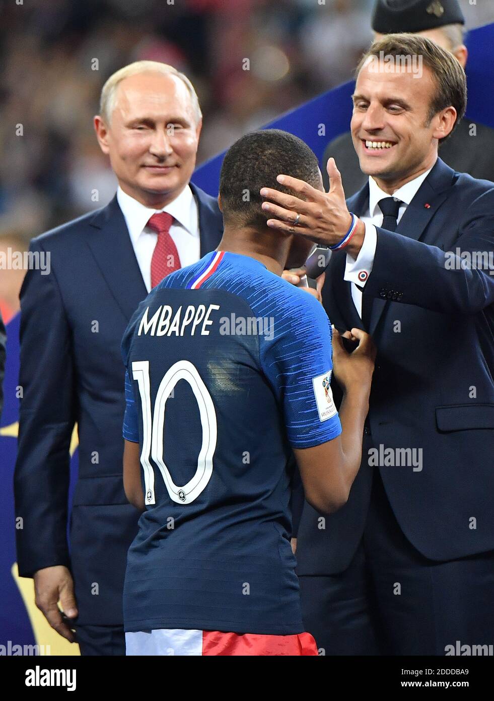 President Emmanuel Macron presents France's forward Kylian Mbappe with ...