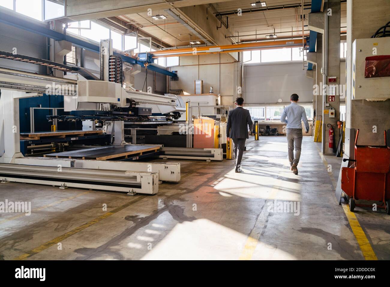 Business people walking at factory Stock Photo - Alamy