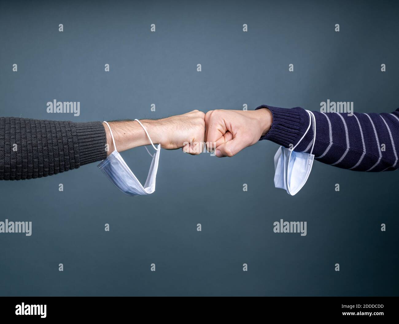 two people greeting each other with knuckles Stock Photo - Alamy