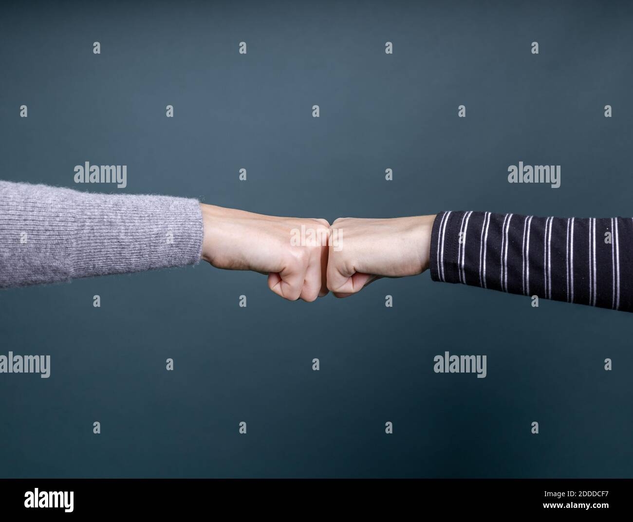 two people greeting each other with knuckles Stock Photo - Alamy